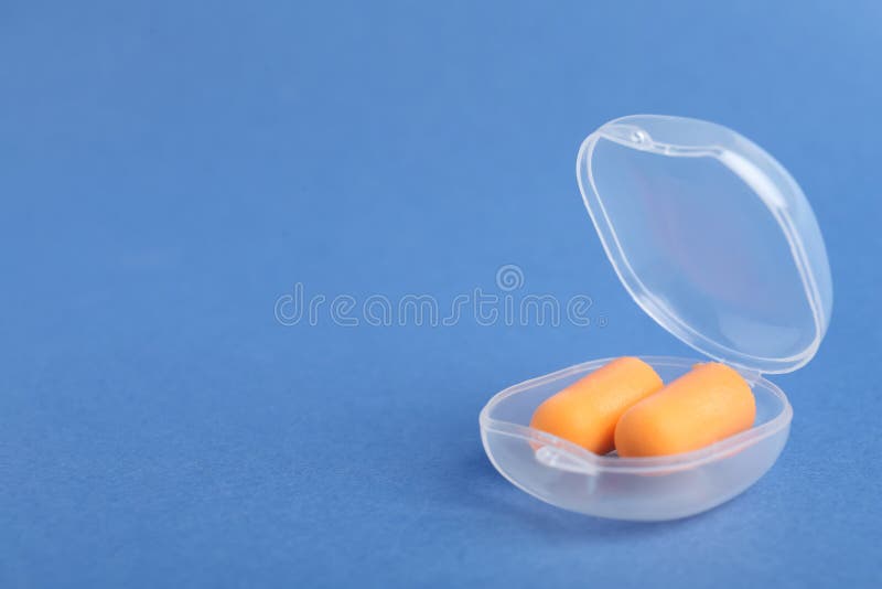 Pair of Orange Ear Plugs in Case on Blue Background. Space for Text ...