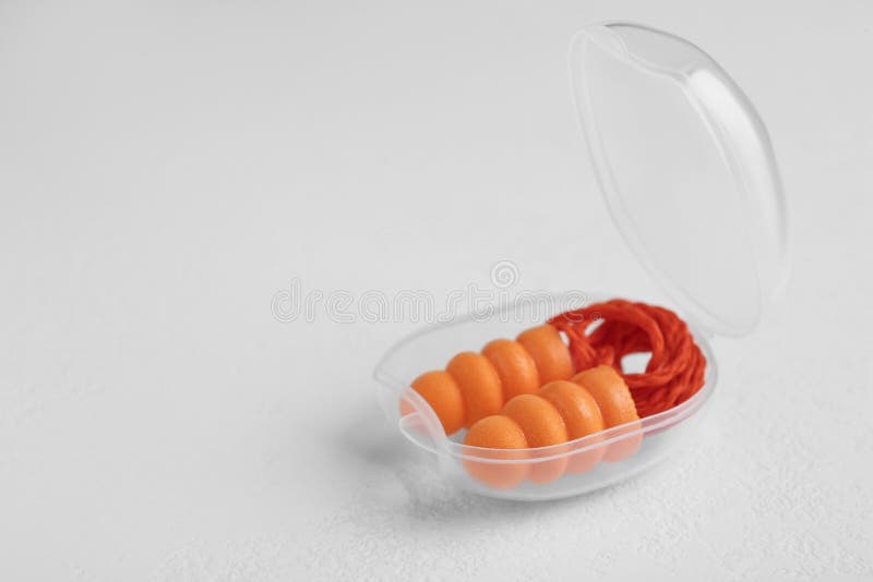 Pair of Orange Ear Plugs with Cord in Case on White Background. Space ...