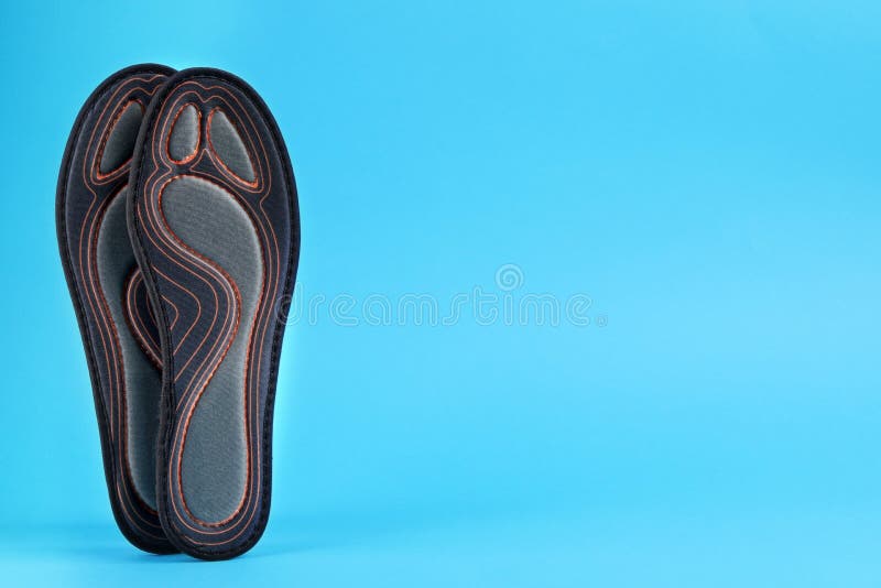 Pair of Orthopedic Insoles on Light Blue Background, Space for Text ...