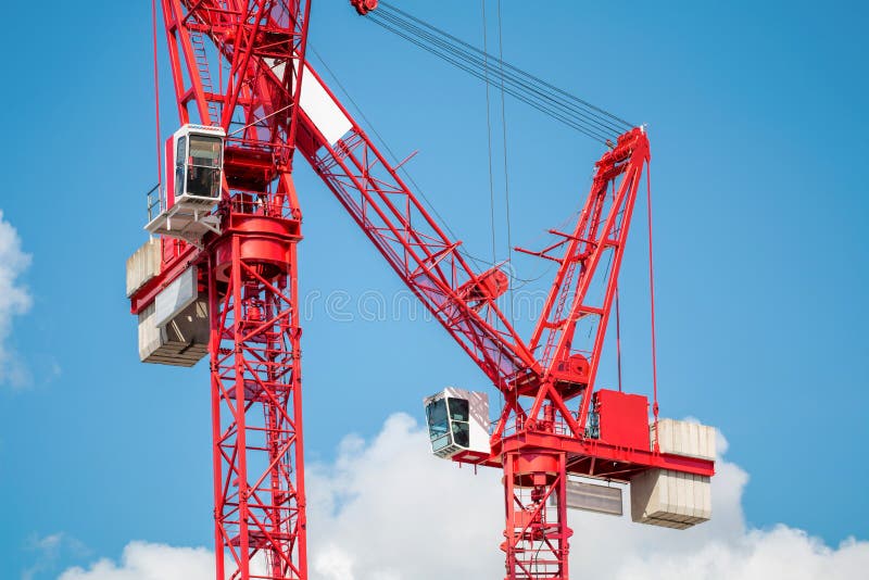 Pair of Red Construction Tower Cranes. Construction Industry Concept ...