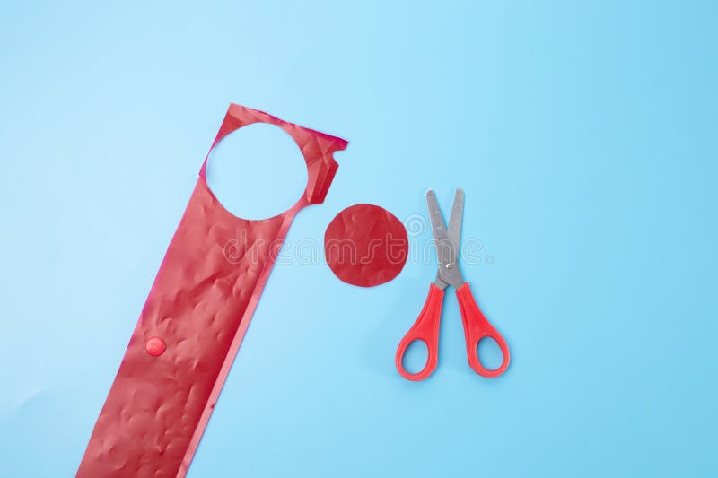 A Pair of Red Scissors Sitting on Top of a Blue Surface,handcrafted ...