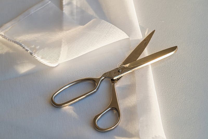 A Pair of Scissors is on a White Cloth. Close Up. Stock Photo - Image ...