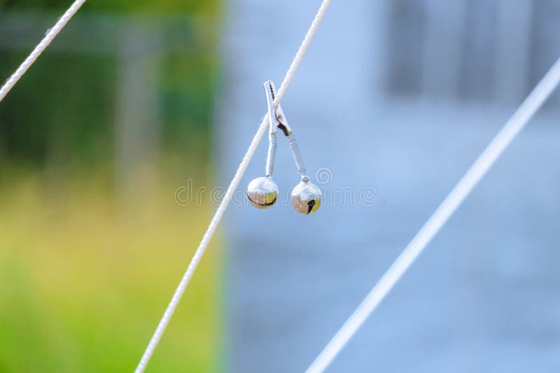 Pair of Silvery Bells with Pin Clasp Hanging on a Rope Stock Image ...