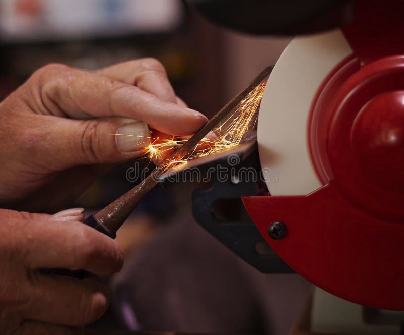 Sharpening a Chisel on a Grinding Wheel. Stock Photo - Image of ...