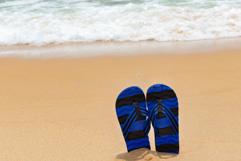 Pair of Slippers in Front of a Beach with Wave Stock Image - Image of ...