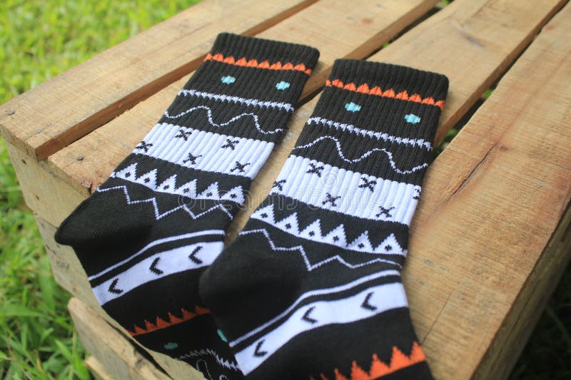 Pair of Socks with Various Patterns on the Side of a Wooden Box Stock ...