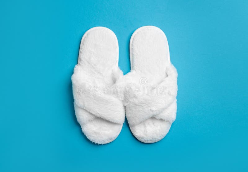 Pair of Soft Fluffy Slippers on Blue Background, Top View Stock Photo ...