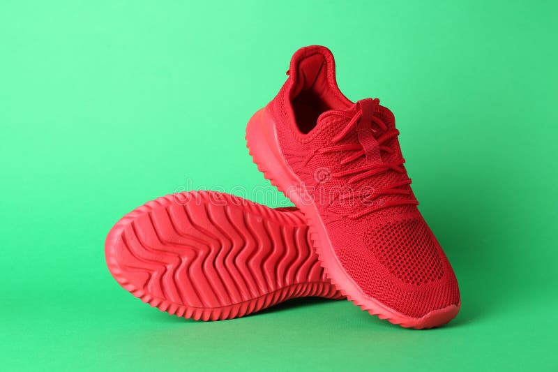 Pair of Stylish Red Sneakers on Green Background Stock Image - Image of ...