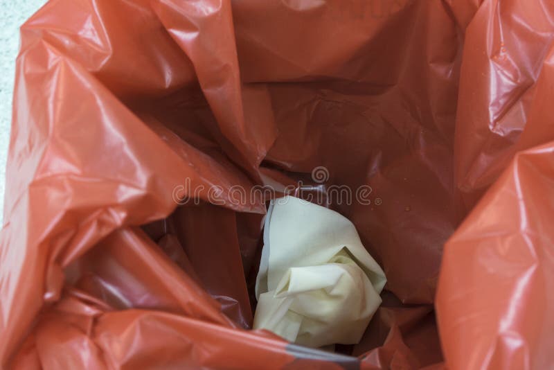 A Pair of Used Gloves Inside a Red Bin for Garbage Stock Photo - Image ...