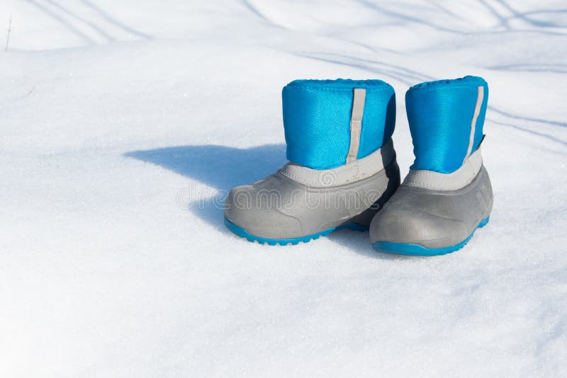 Pair of Waterproof Children Boots on the Snow Stock Photo - Image of ...