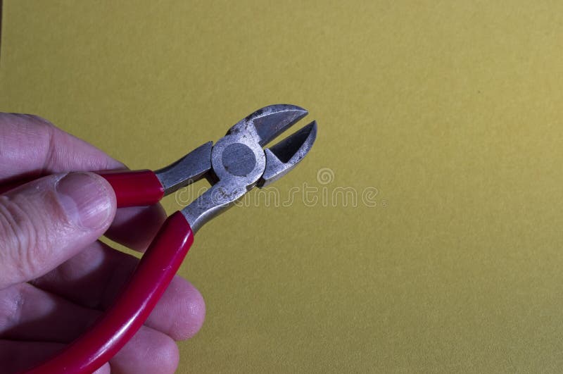 A Pair of Wire Cutters Held in Hand Stock Photo - Image of held, yellow ...