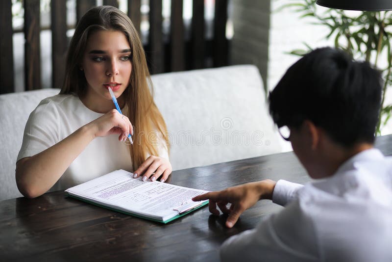 A Pair of Young People Talking at the Office Stock Photo - Image of ...