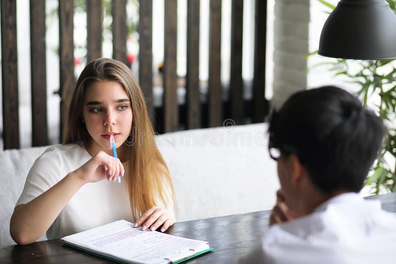 A Pair of Young People Talking at the Office Stock Photo - Image of ...