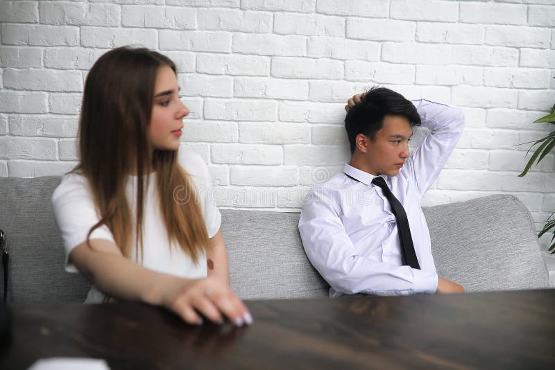 A Pair of Young People Talking at the Office Stock Photo - Image of ...