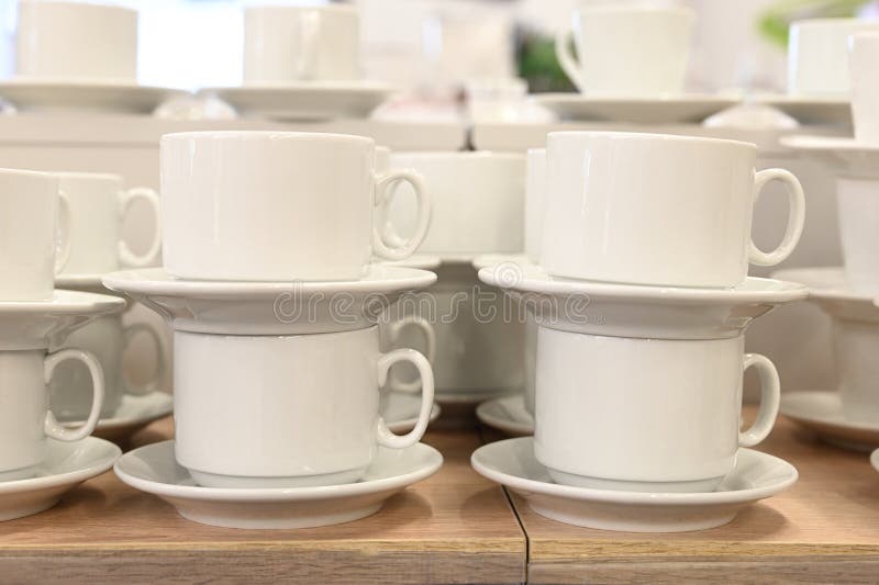 Pairs of Mugs and Plates on Shelf of the Tableware Store. a Lot of Rows ...