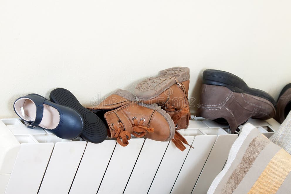 Pairs of shoes on radiator stock image. Image of fashion - 37807549