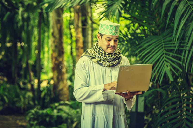 Pakistani Muslim Man Stand and Working on Notebook Stock Image - Image ...