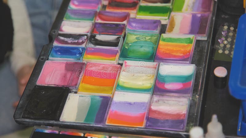 Open Palette of Vibrant Face Paints on a Table, Ready To Transform ...