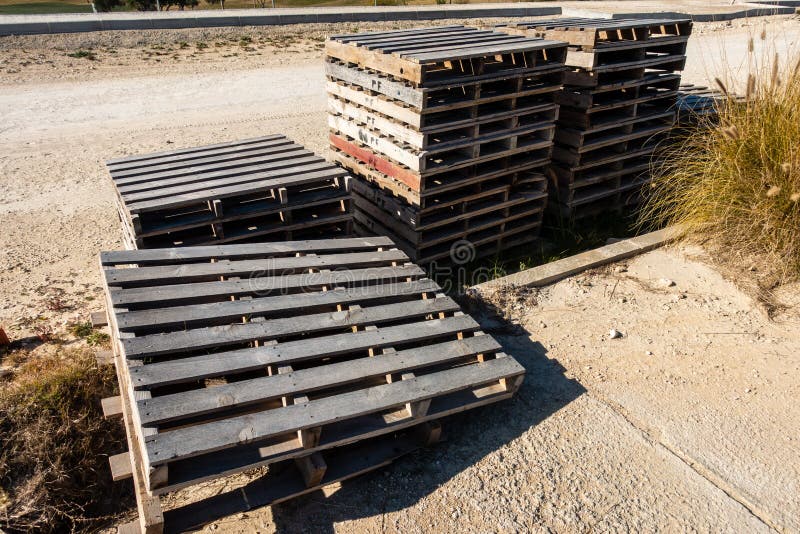Pallets piled at roadside stock image. Image of street - 169516849