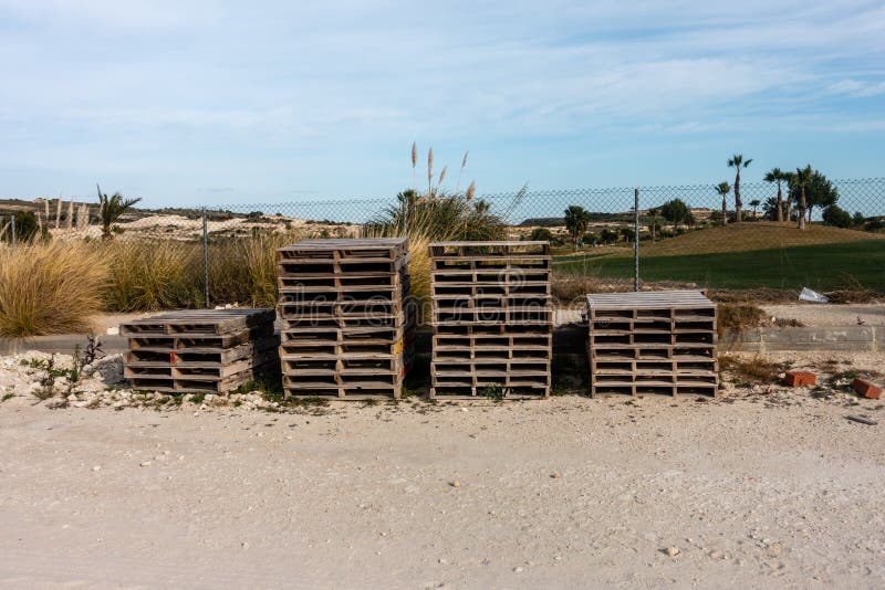 Pallets piled at roadside stock photo. Image of wood - 169672008