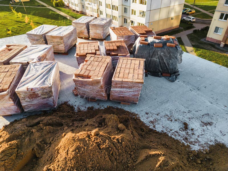 Pallets with Red Ceramic Bricks on the Roof of a Building Under ...