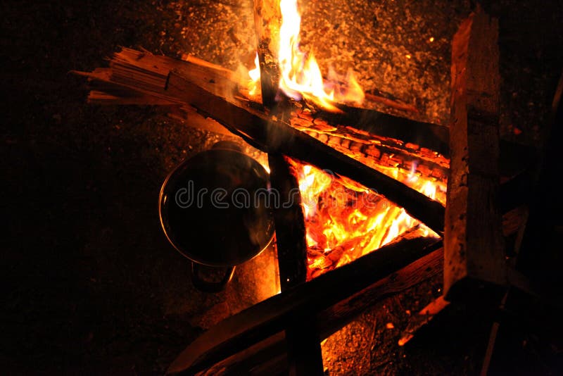 Burning Bonfire and Pot of Water Stock Image - Image of smudge, logs ...