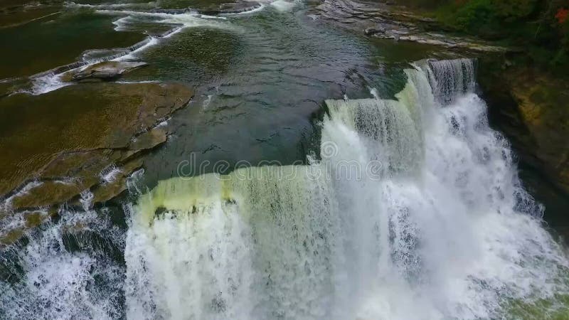 Pan Down Over Edge of Huge Raging Waterfall Pouring Over Cliffs ...