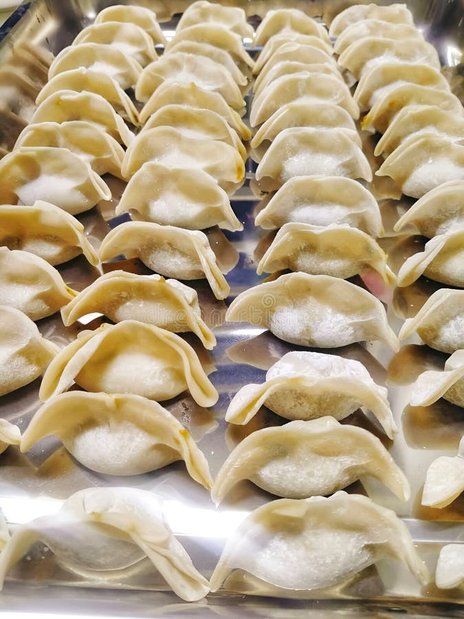 A Pan Filled with Dumplings Sitting on Top of a Table. Stock Photo ...