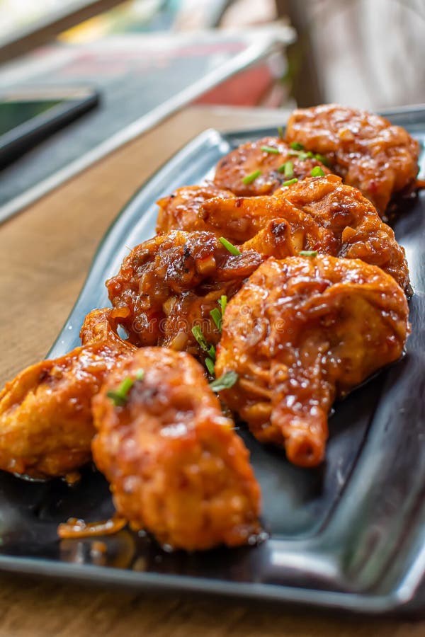 Pan Fried Chicken Momo Served in a Black Plate Over Moody Background ...