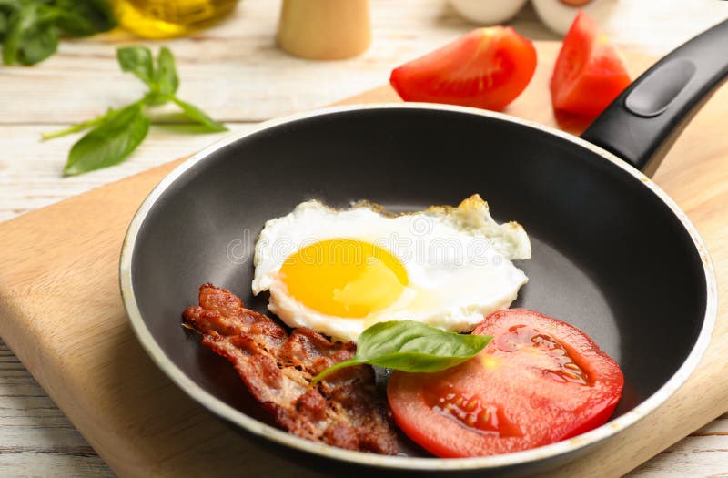 Pan with Fried Sunny Side Up Egg, Bacon and Tomato Stock Image - Image ...