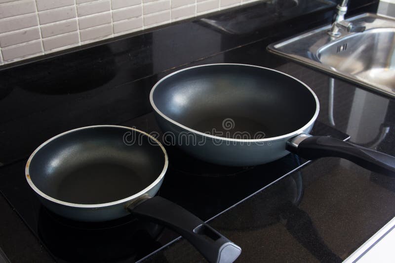 Pan on induction cooker stock photo. Image of interior - 128317816
