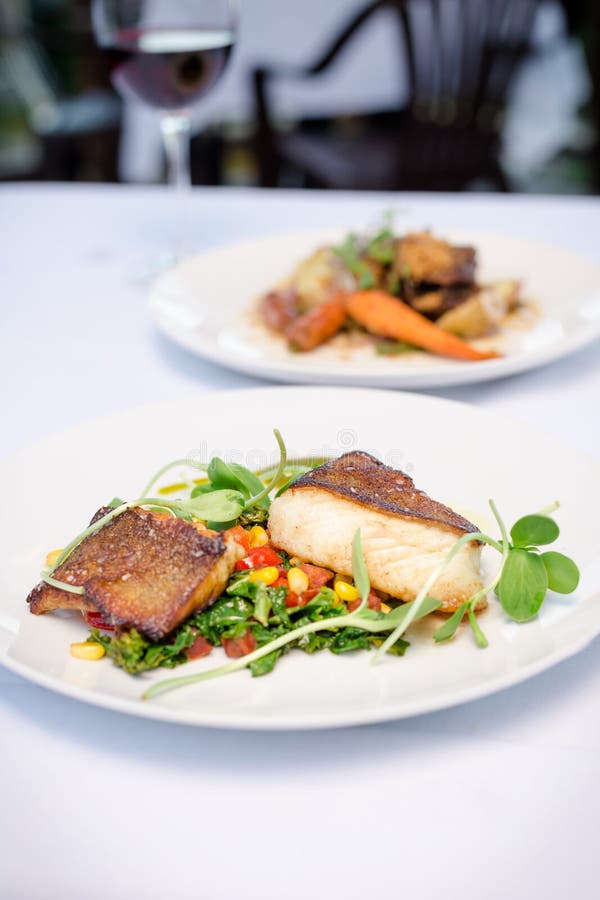 Pan Roasted Sable Fish with Spring Vegetables on a White Plate in a ...