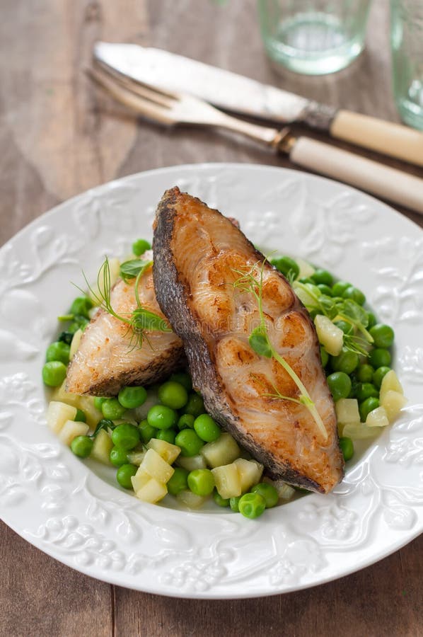 Pan Seared Halibut with Sauteed Peas Stock Photo - Image of dinner ...