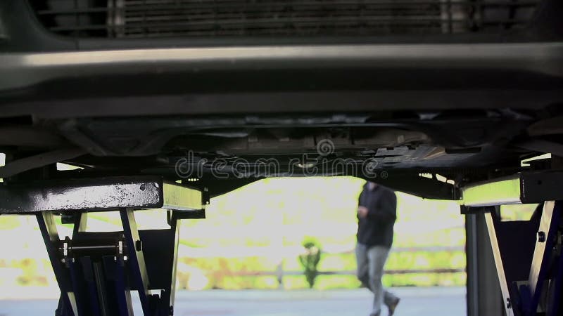 Pan Shot of a Tireless Car with a Walker in the Background Stock ...