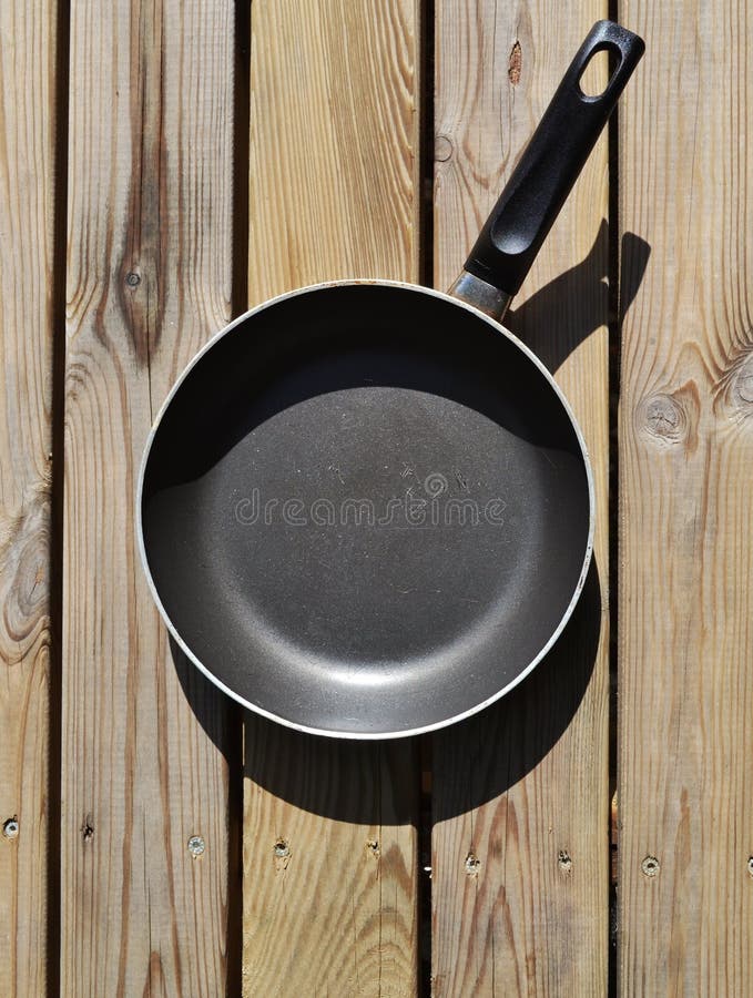 Pan in a wooden table stock image. Image of dinner, chef - 114658381