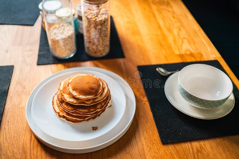Pancake Stack on a Plate for Breakfast Near a Cereal Bowl Stock Photo ...