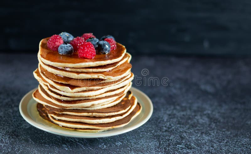 Pancakes with Berries and Honey on Dark Background with Copy Space ...