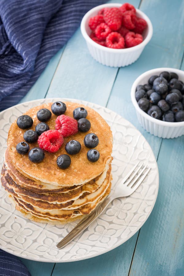 Pancakes with Blueberries and Raspberry on Blue Wood Background Stock ...