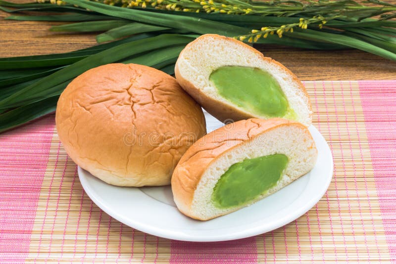 Pandan Custard Bun on Bamboo Mat with Pandan Leaf Still Life St Stock ...