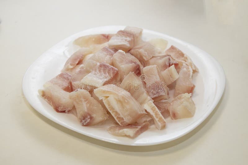 Pangasius Fish Fillet by Pieces on the White Plate. Fresh Fish Fillet ...