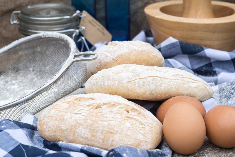 Panini Rolls in Rustic Kitchen Setting with Cooking Utensils Stock ...