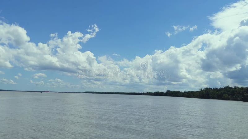 Panning of a Beautiful Cloudy Sky and Sun Rays from the White Cloud, River, River Waves, and ...