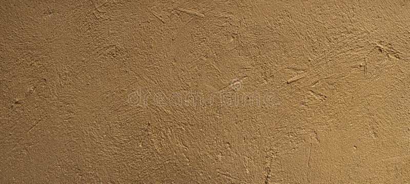 The Exterior Cement Wall of the Building is Painted Brown with a Rough ...