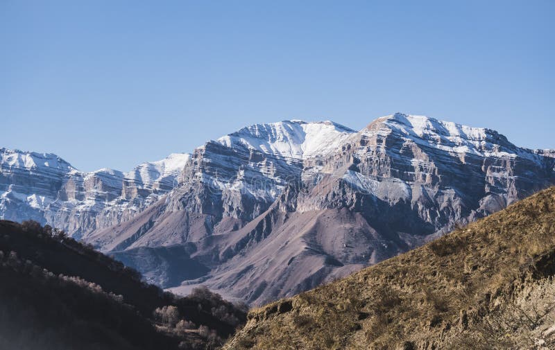 Panorama of a Mountain Range from Layers of Rocks with the First Snow ...