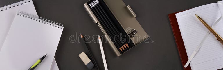 Panorama with Pencils, Notepad and Notebook on a Gray Background Stock ...