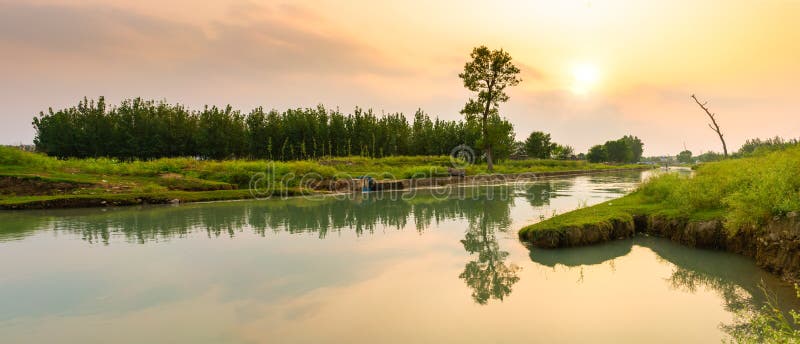 Panorama of a River Surrounded by Greenery with Trees Reflecting on the ...