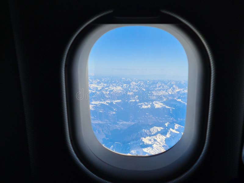 Panorama of the Snow Capped Alps in the Window of an Airplane Flying ...