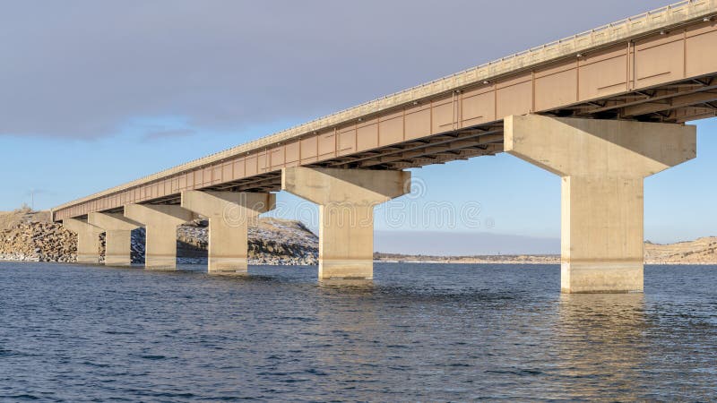 Panorama Stringer Bridge Spanning Over a Lake with View of Snowy ...