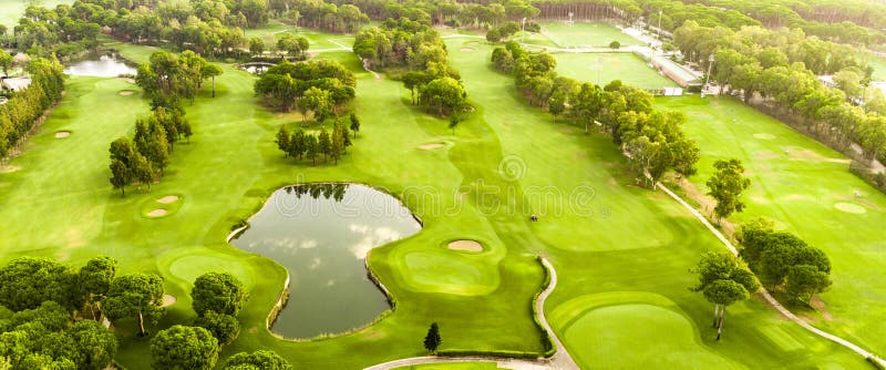 A Panoramic Aerial View of a Golf Course with a Scenic Pond and Lush ...