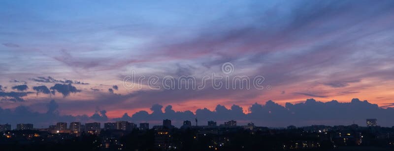 Panoramic Cityscape with Clouds in the Sunset Sky Repeating the ...